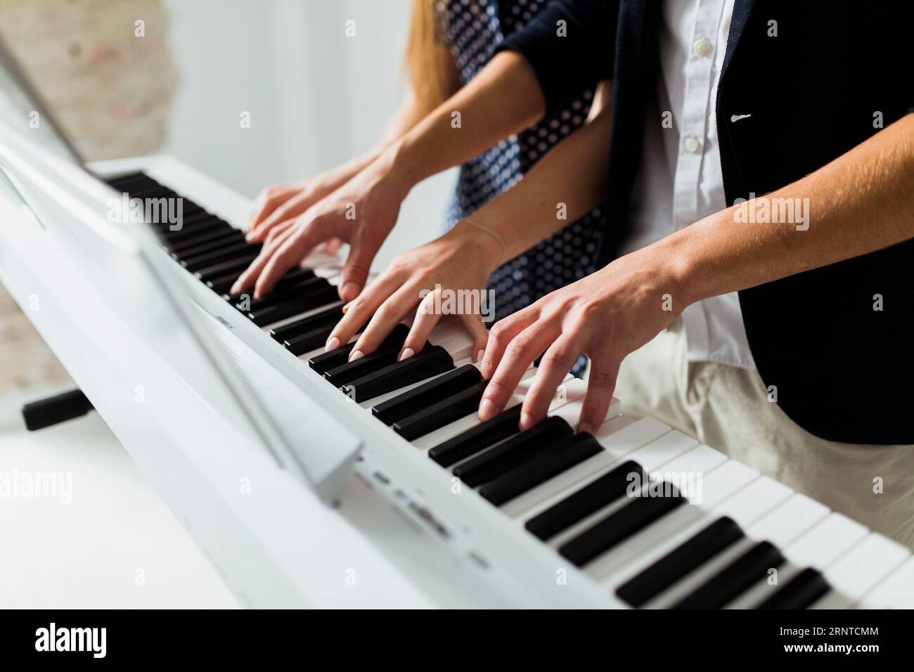 Close up couple s hand playing piano keyboard Stock Photo - Alamy