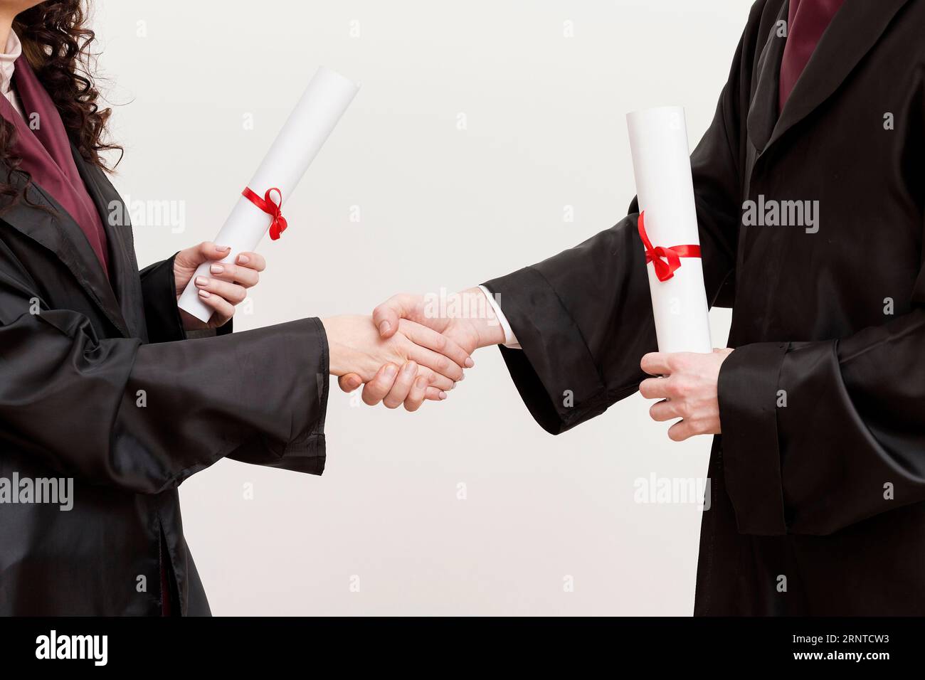 Close up graduates shaking hands Stock Photo - Alamy