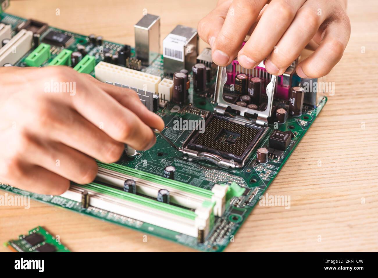 Close up male technician repairing cpu socket wooden table Stock Photo ...