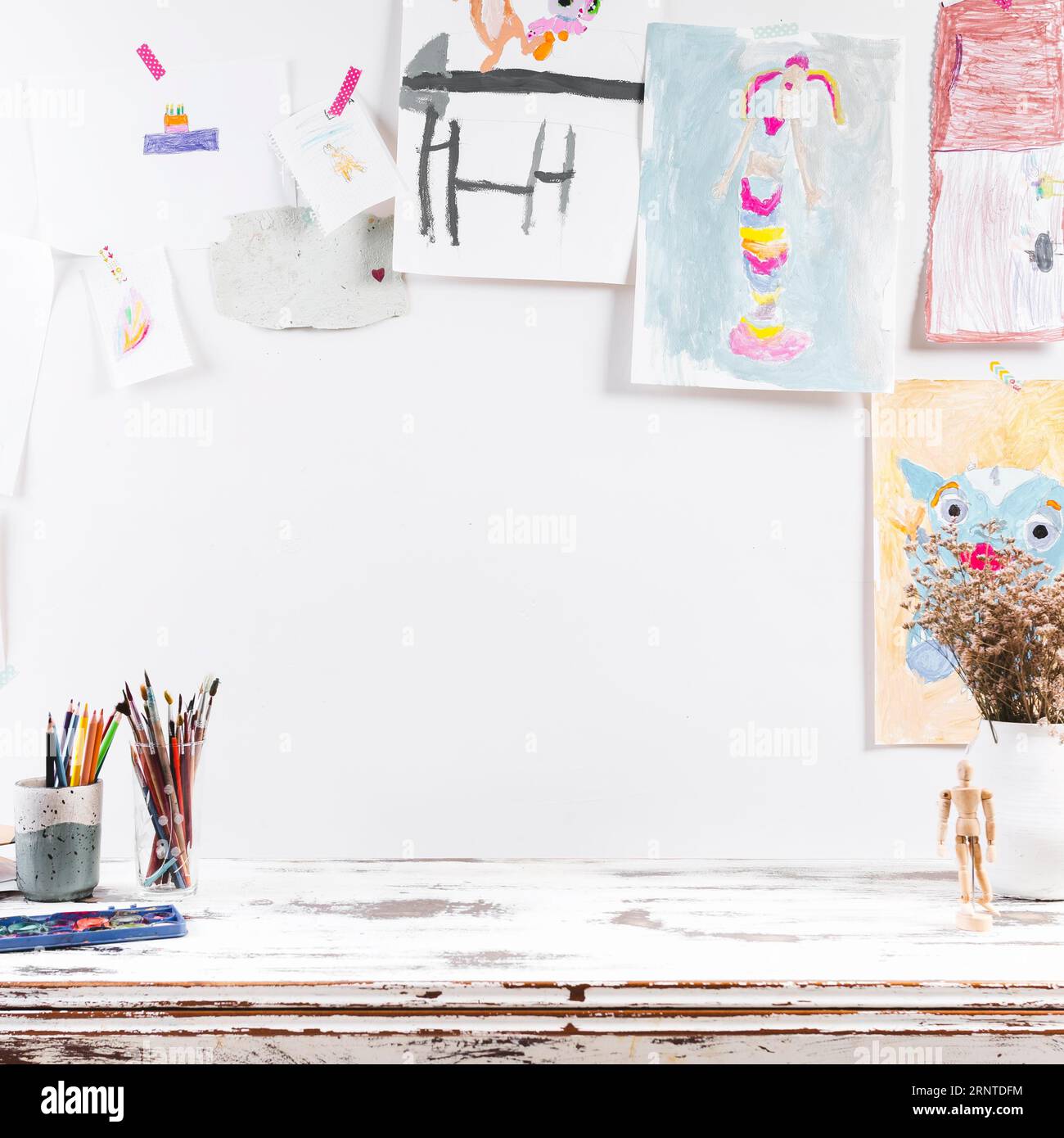 Drawing table with children paintings Stock Photo - Alamy