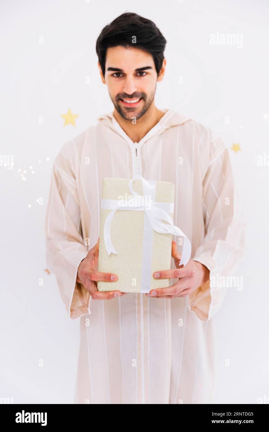 Muslim man holding gift box hi-res stock photography and images - Alamy