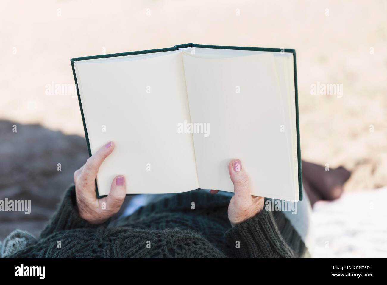 Hands holding blank book Stock Photo - Alamy