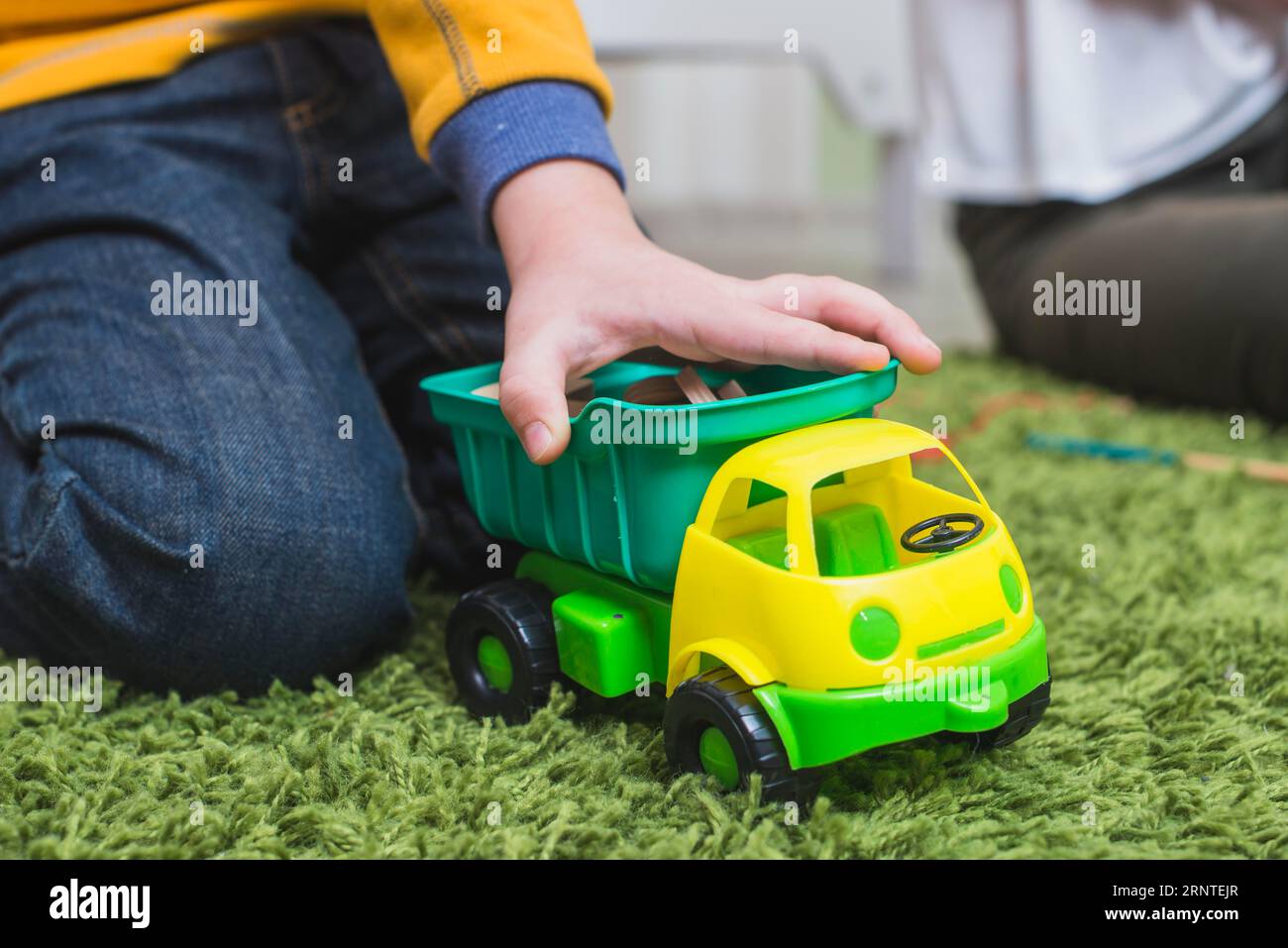Kid playing toy car floor Stock Photo - Alamy