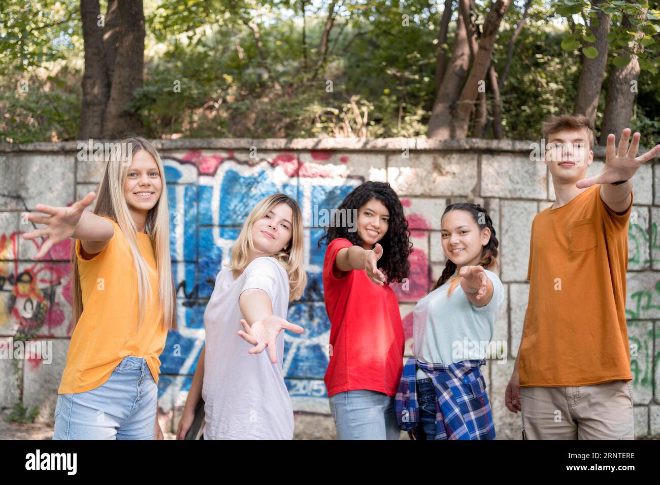 Medium shot friends posing together Stock Photo - Alamy