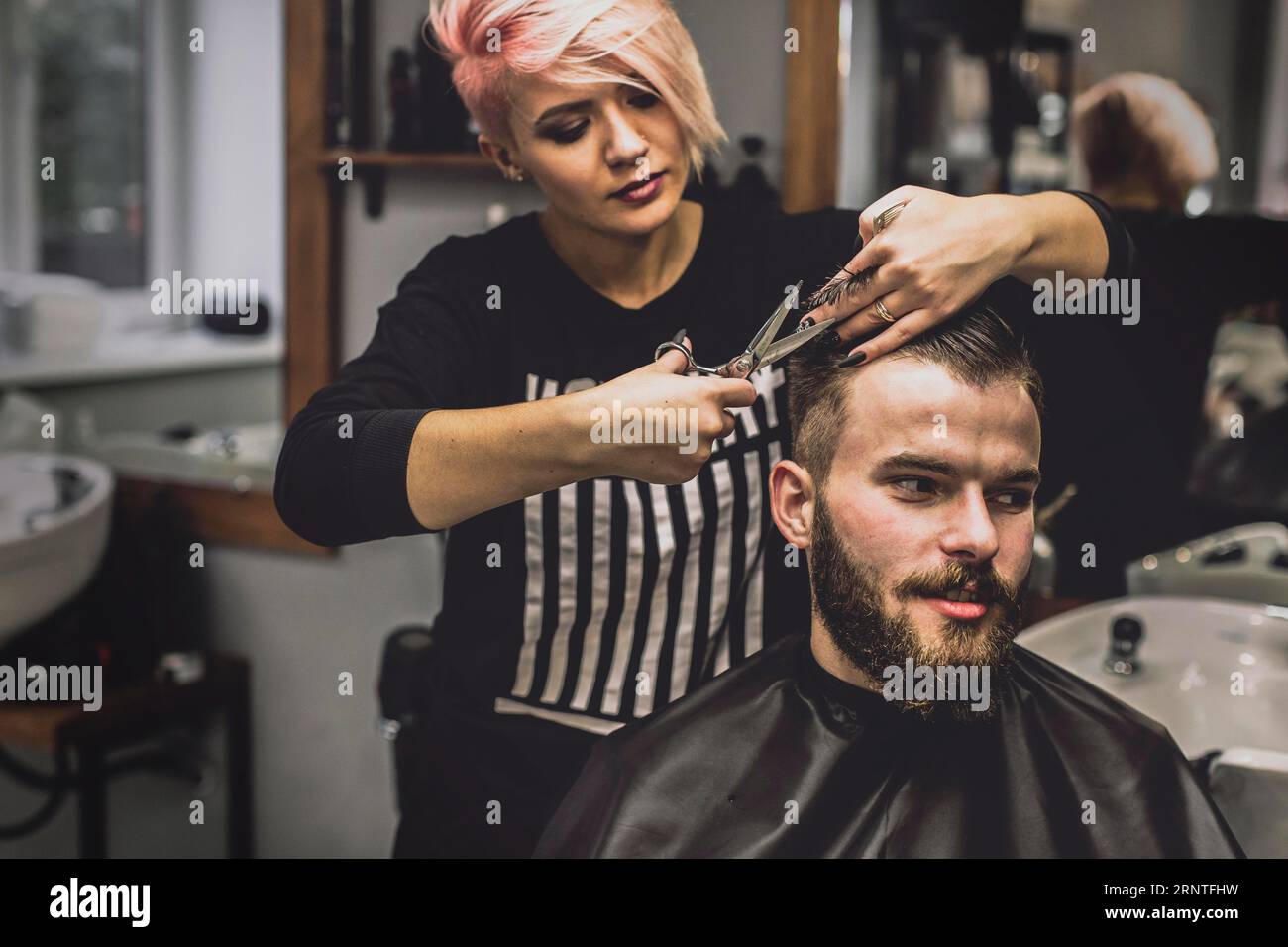 Pretty woman grooming hair man Stock Photo - Alamy