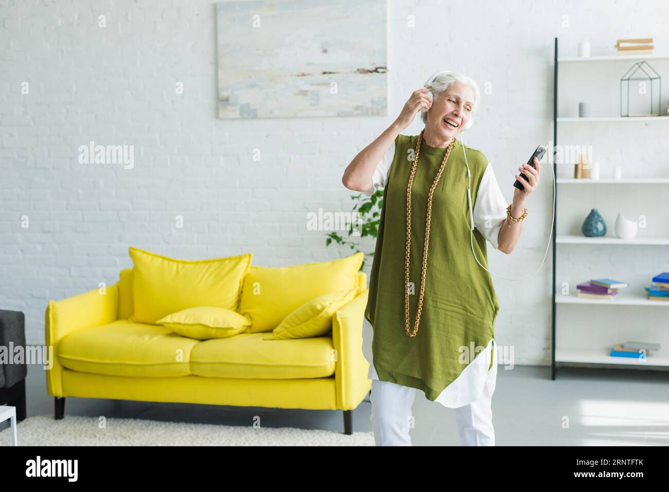 Listening music through smartphone headphone hi-res stock photography ...