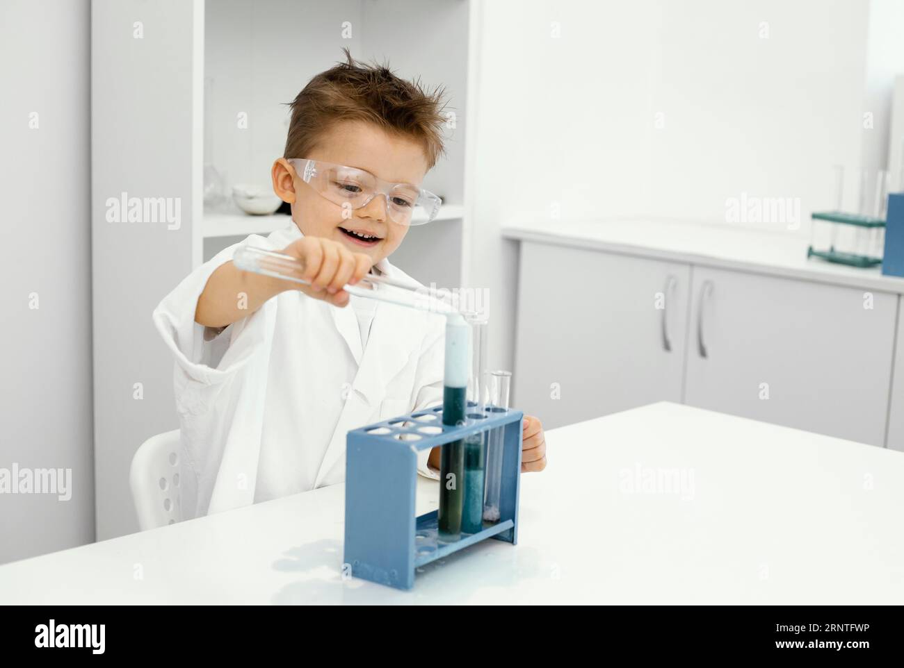 Smiley boy scientist laboratory with test tubes doing experiments Stock ...