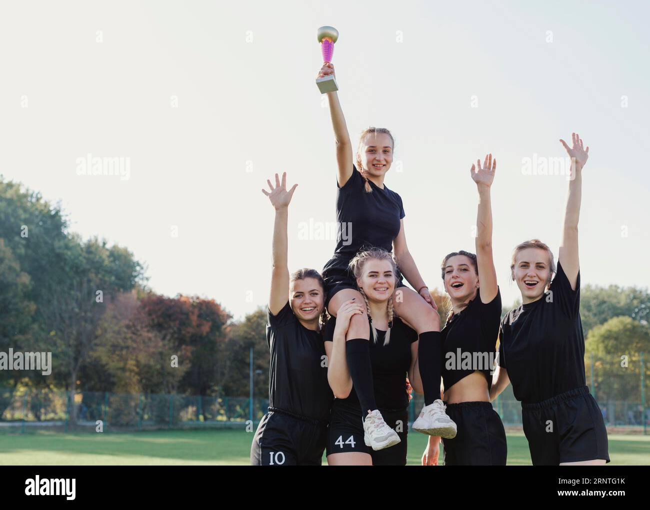 Sportive girls winning trophy Stock Photo - Alamy