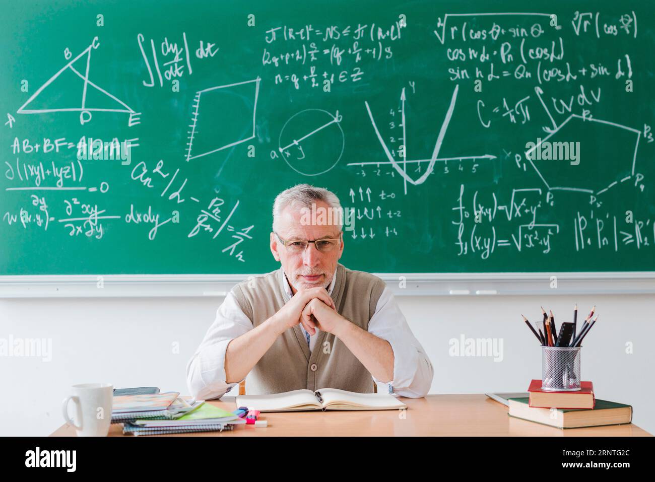 Strict teacher looking camera classroom Stock Photo - Alamy