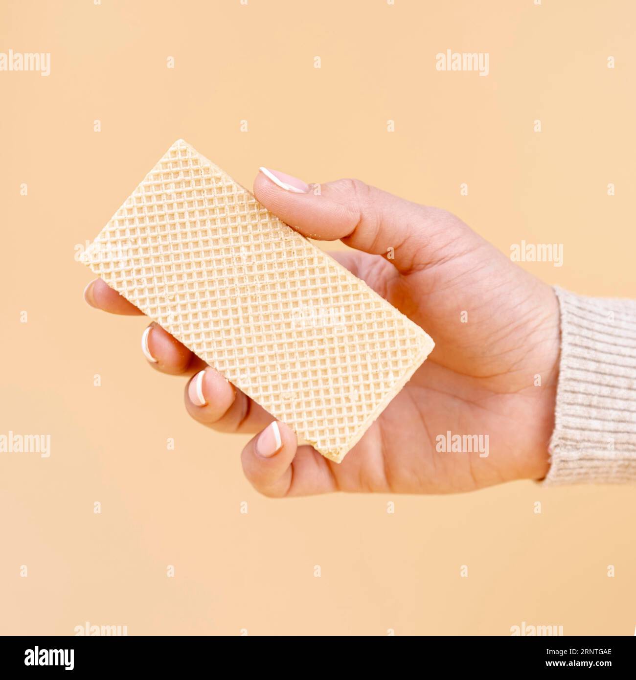 Front view hand holding one piece wafer Stock Photo - Alamy