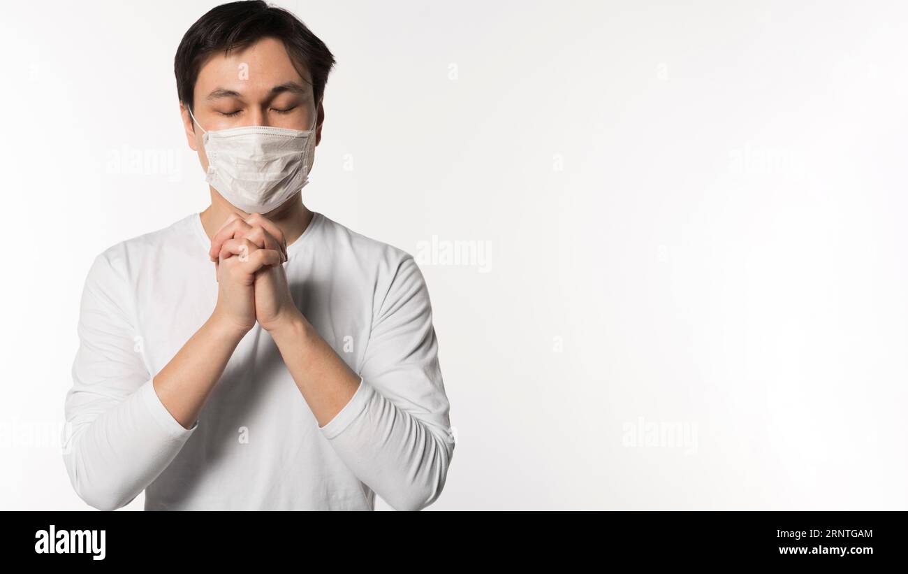 Front view sick man with medical mask praying Stock Photo - Alamy