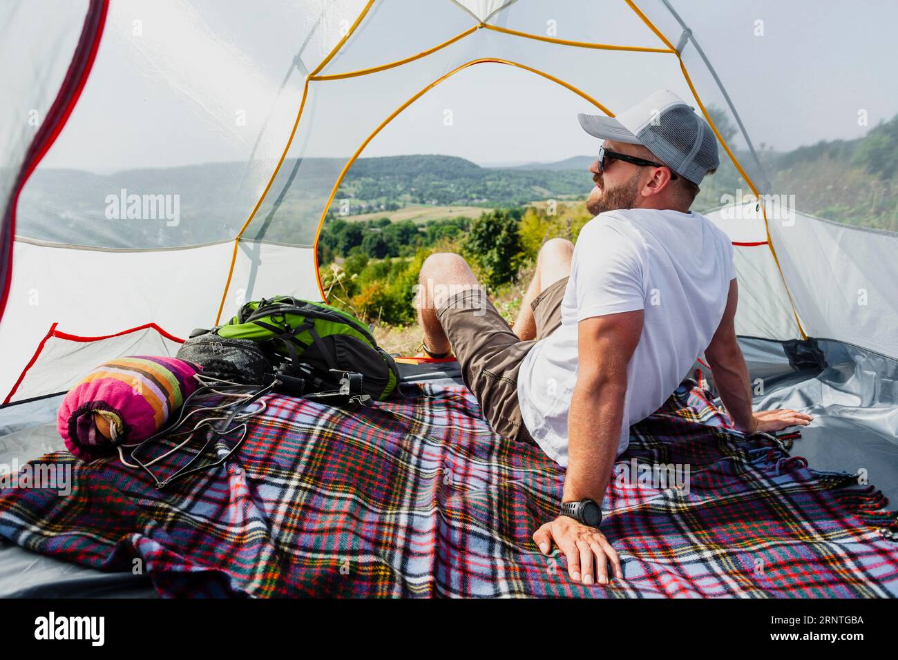 Front view man tent enjoying view Stock Photo - Alamy