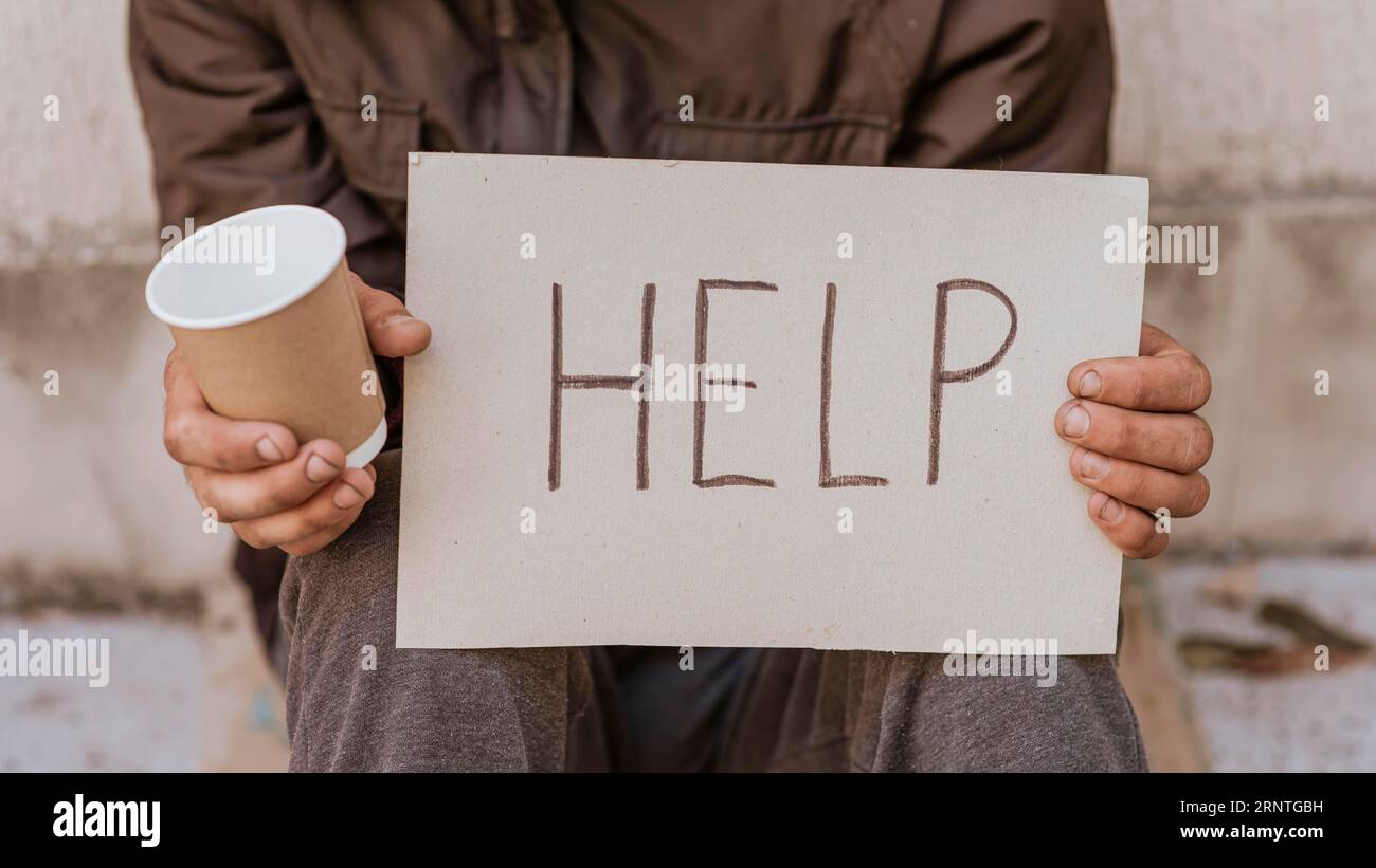 Front view homeless man holding help sign cup Stock Photo - Alamy