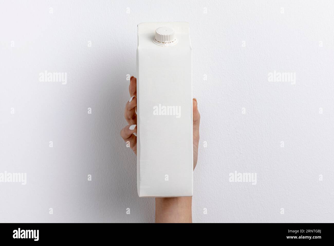 Front view hand holding simple milk carton Stock Photo - Alamy