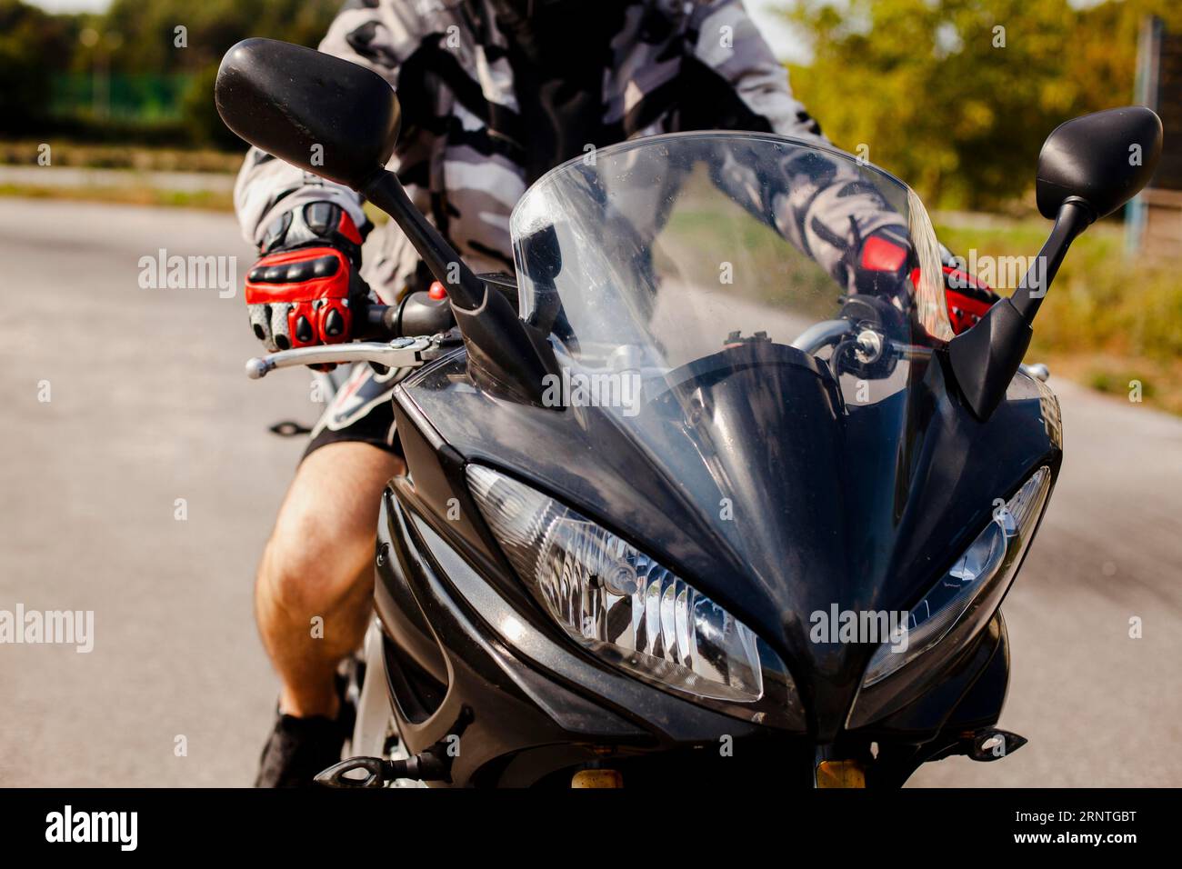 Front view motorbike with biker Stock Photo - Alamy