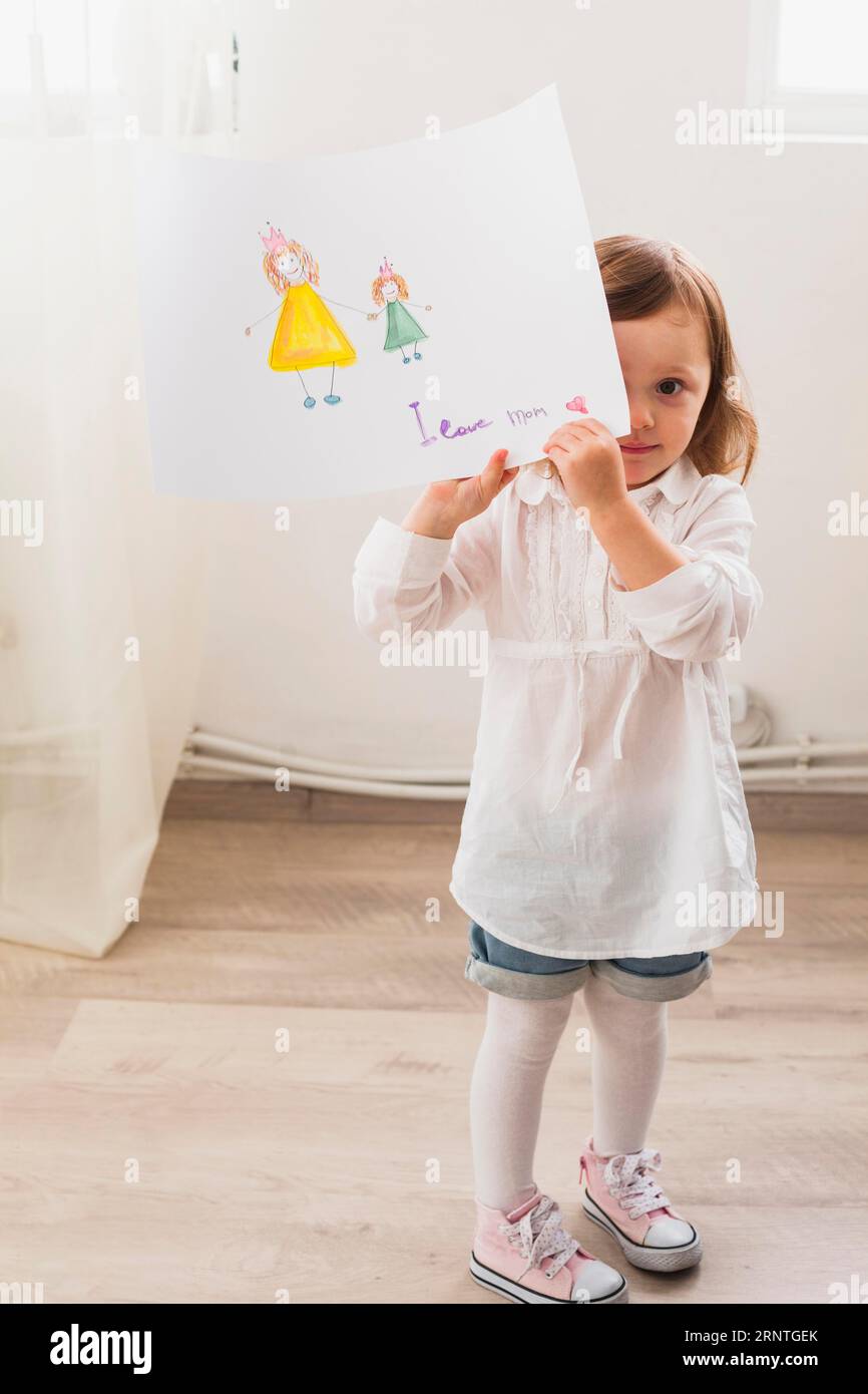Girl standing with drawing mother child Stock Photo - Alamy
