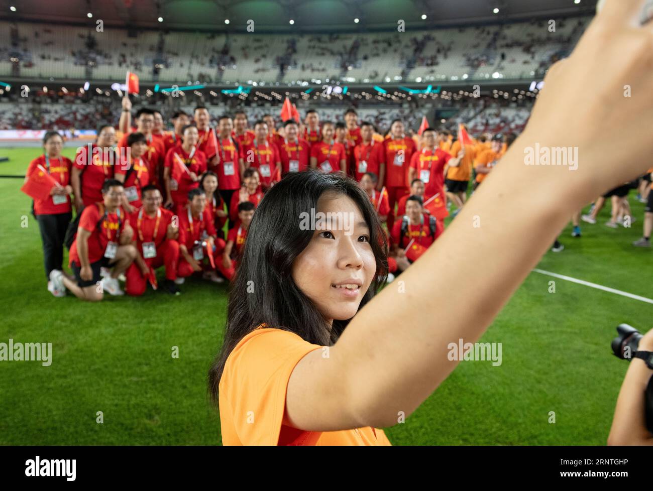 Chinese volunteer takes a selfie with the Chinese team during the ...