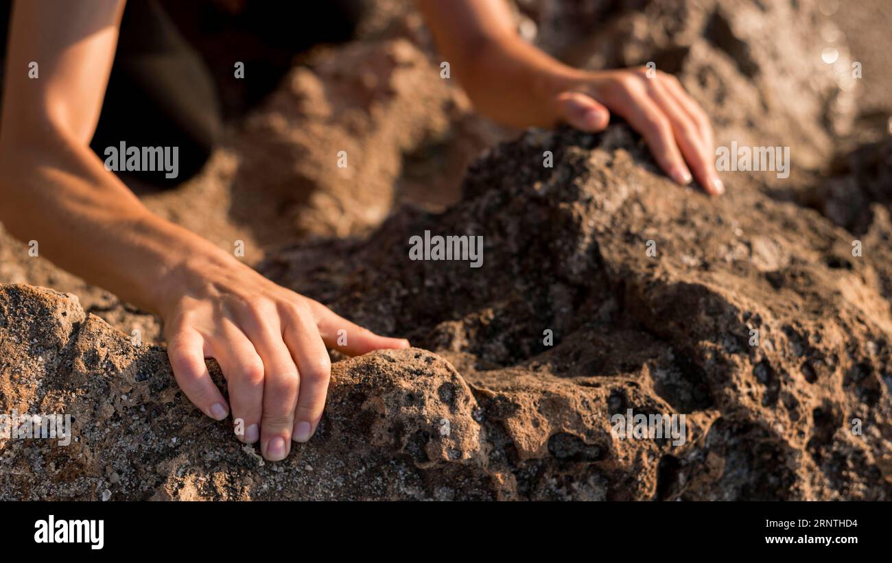 Woman holding her hands ground Stock Photo - Alamy