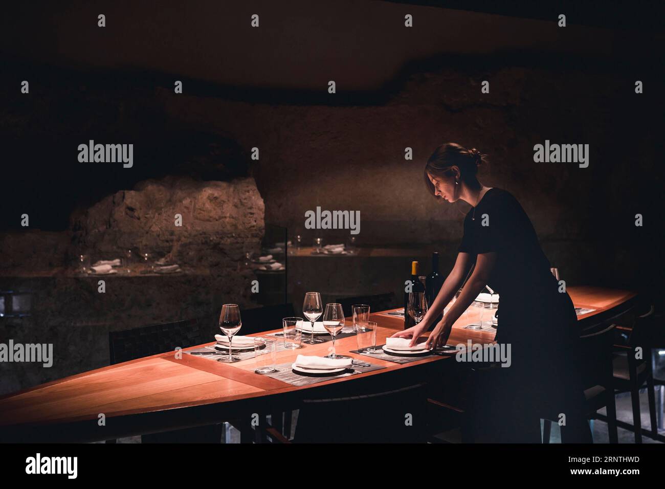 Young waitress setting table Stock Photo - Alamy