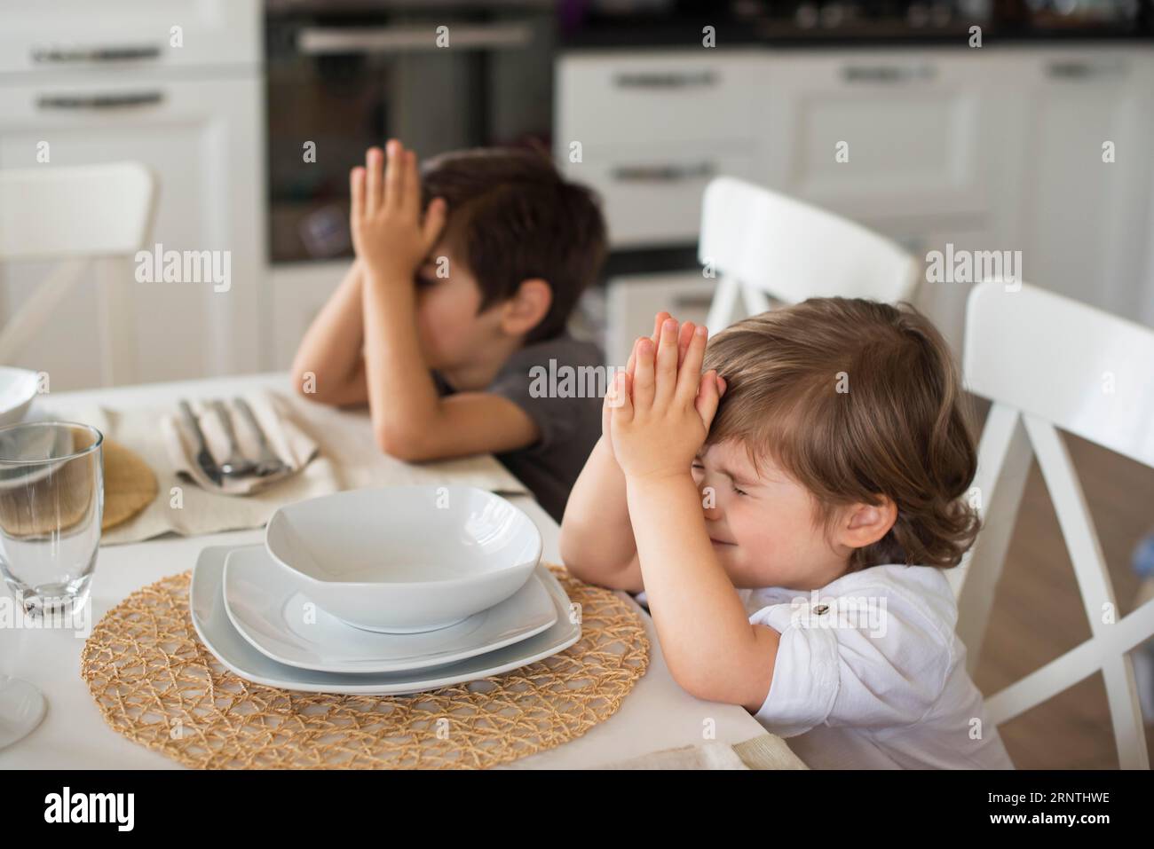 Adorable children praying home Stock Photo - Alamy