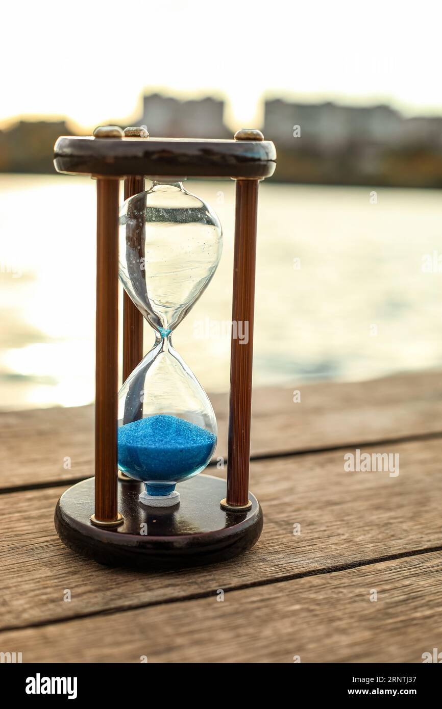 Hourglass on bridge near river, closeup Stock Photo - Alamy