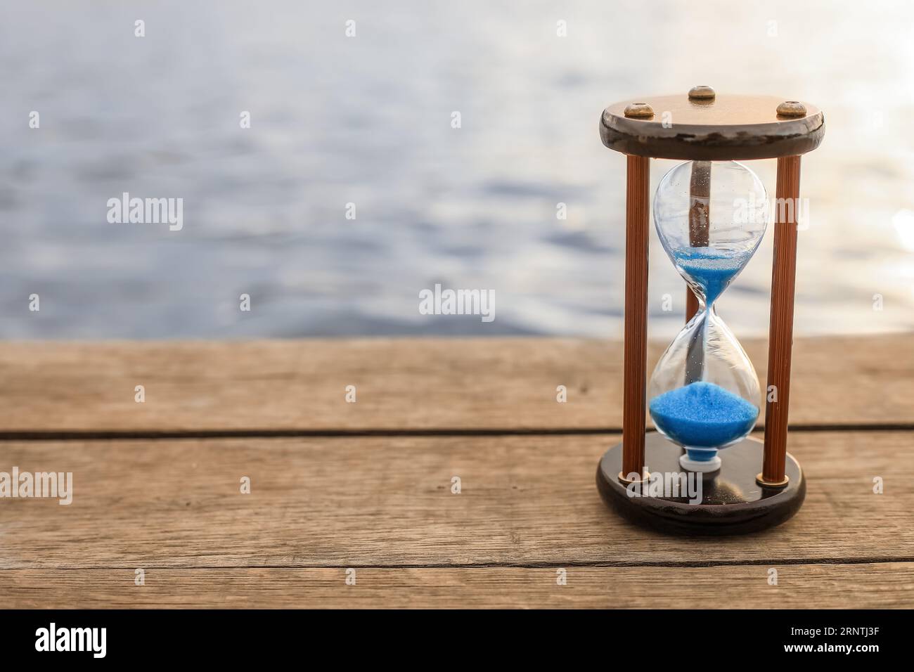 Hourglass on bridge near river, closeup Stock Photo - Alamy