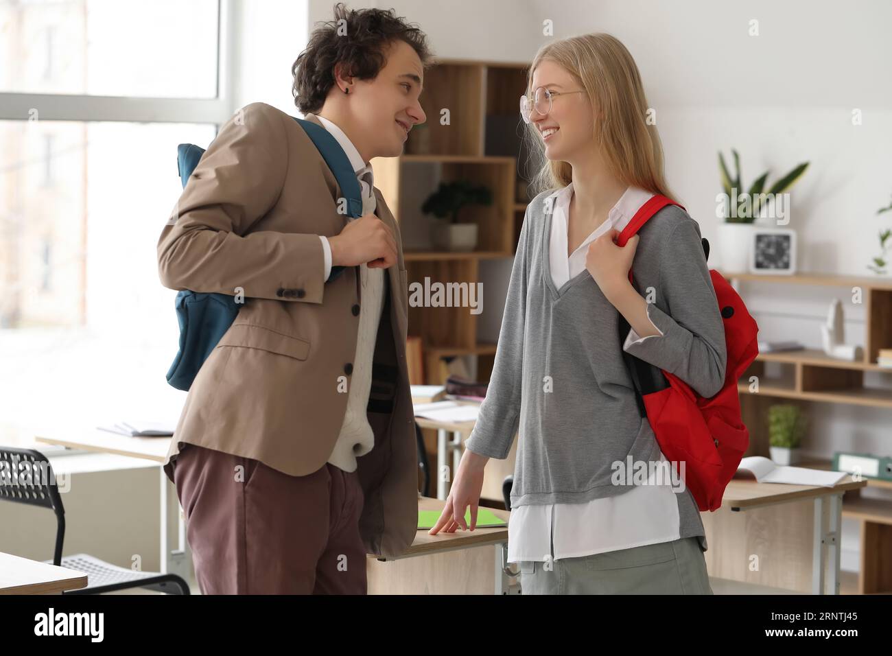 Cute teenage couple in classroom Stock Photo - Alamy