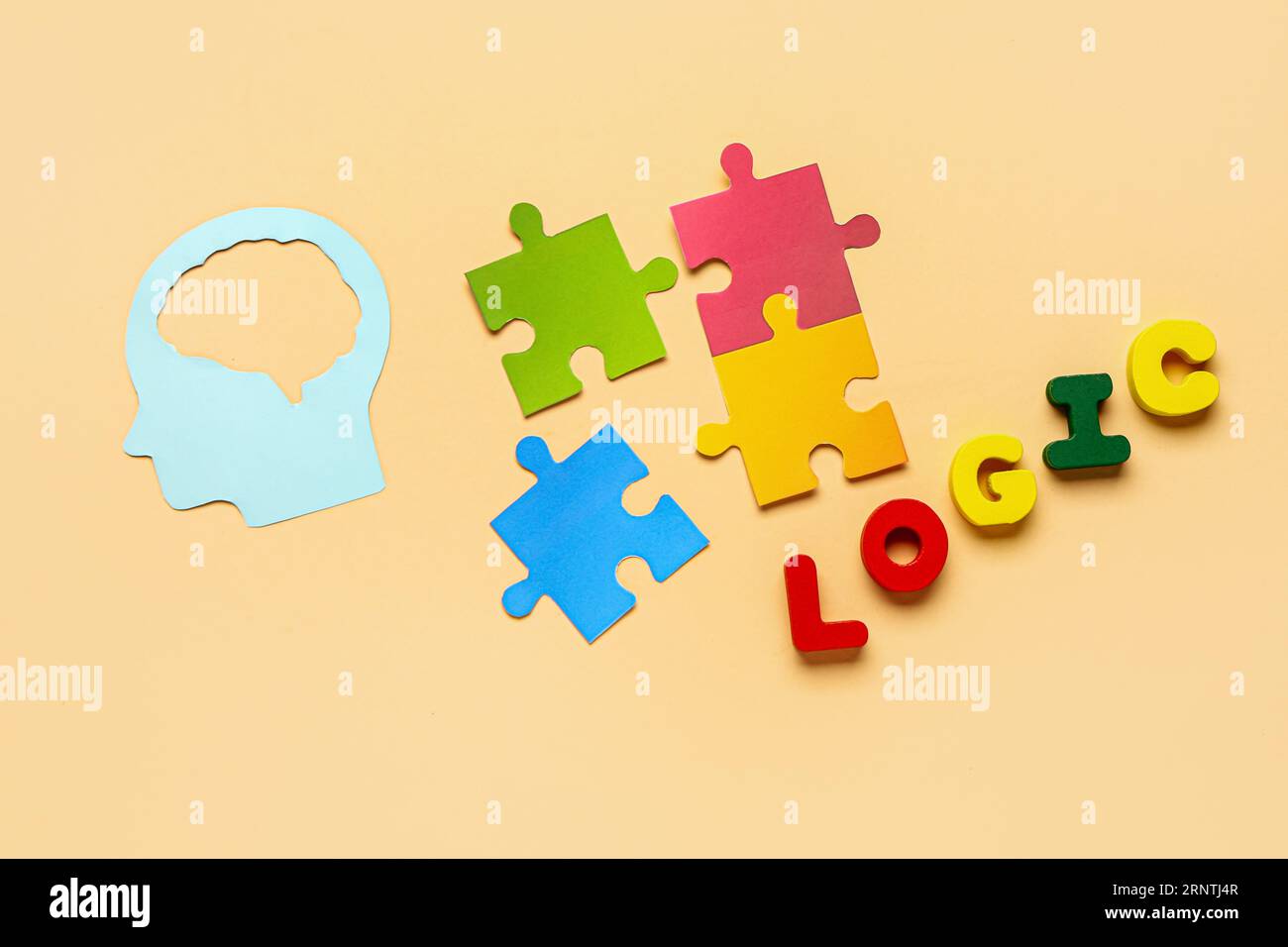 Word LOGIC with puzzle pieces and paper human head on beige background ...