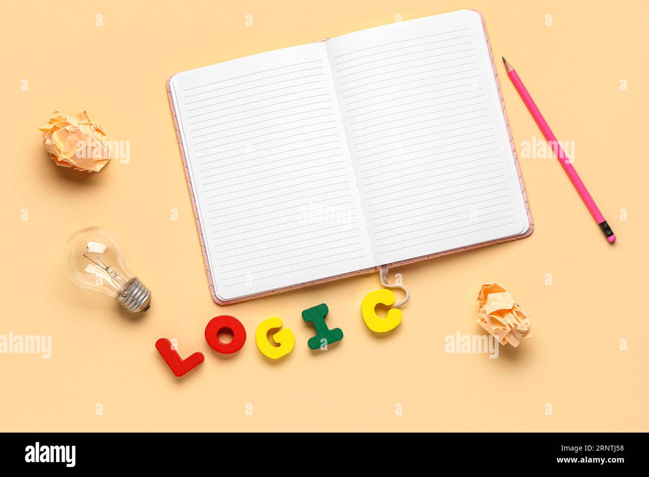 Word LOGIC with light bulb, notebook and crumpled paper on beige ...