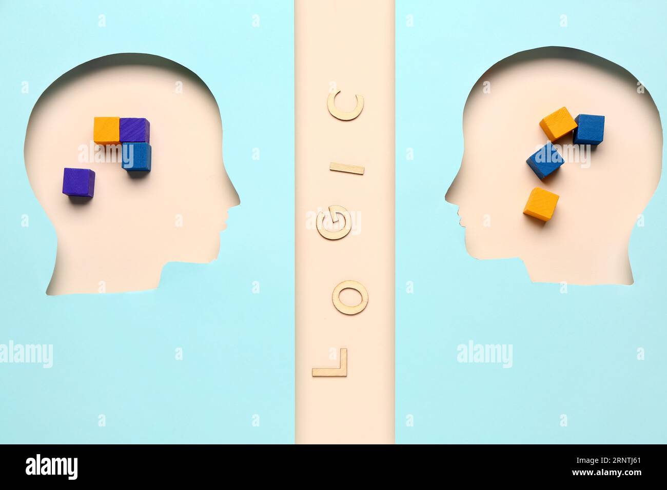 Cubes visible through cut blue papers in shape of human heads and word ...