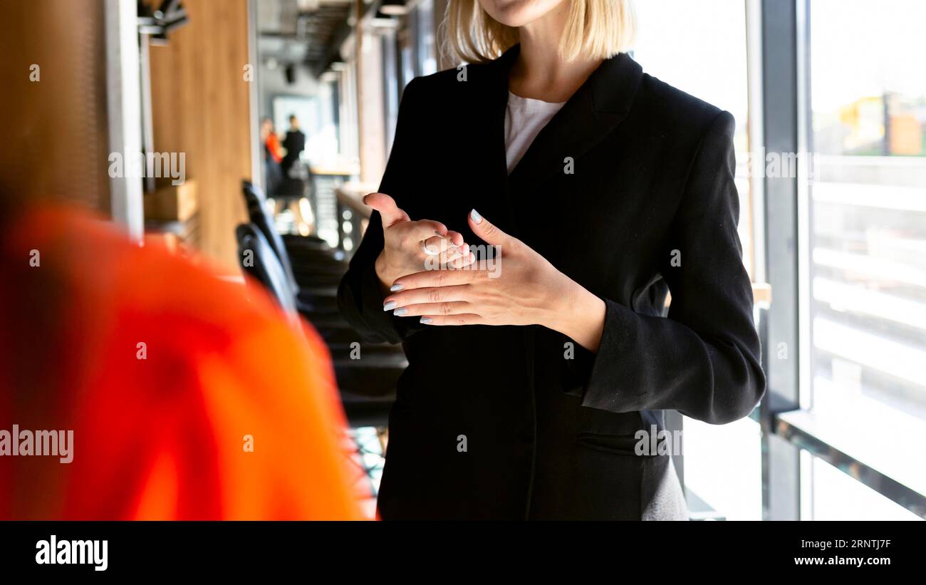 Businesswoman using sign language work Stock Photo - Alamy