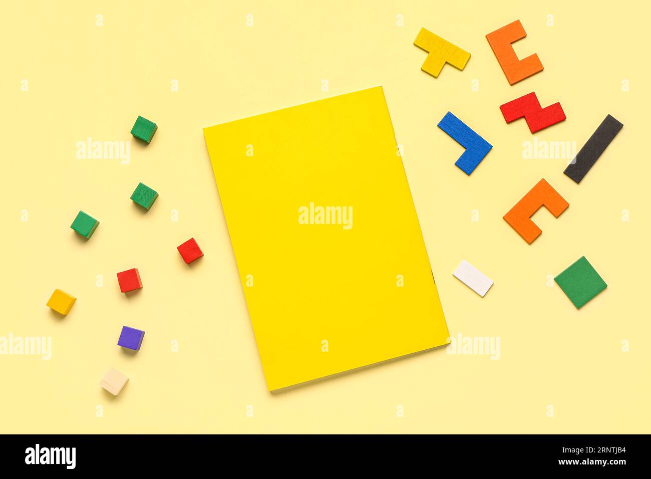 Notebook with cubes and blocks on yellow background. Logic concept ...