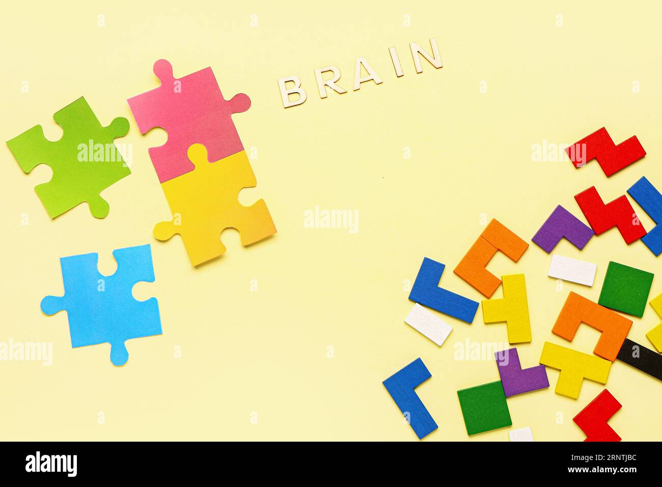 Word BRAIN with puzzle pieces and blocks on yellow background. Logic ...