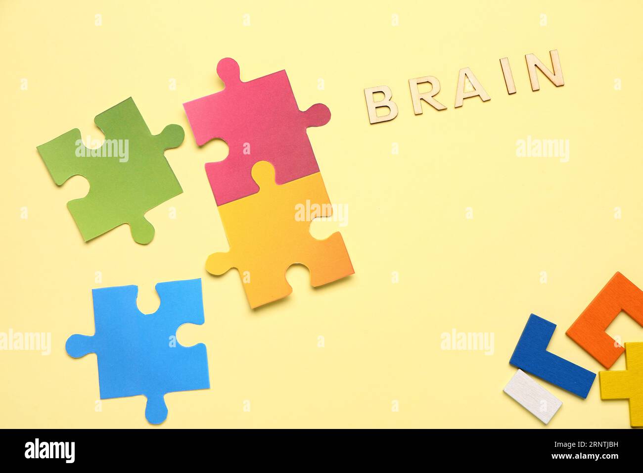 Word BRAIN with puzzle pieces and blocks on yellow background. Logic ...