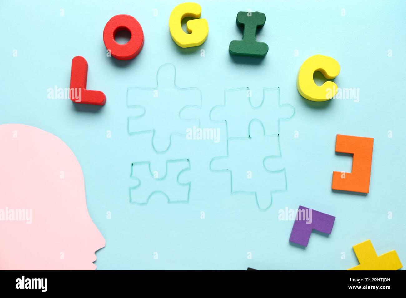 Word LOGIC with drawn puzzle pieces, blocks and paper human head on ...