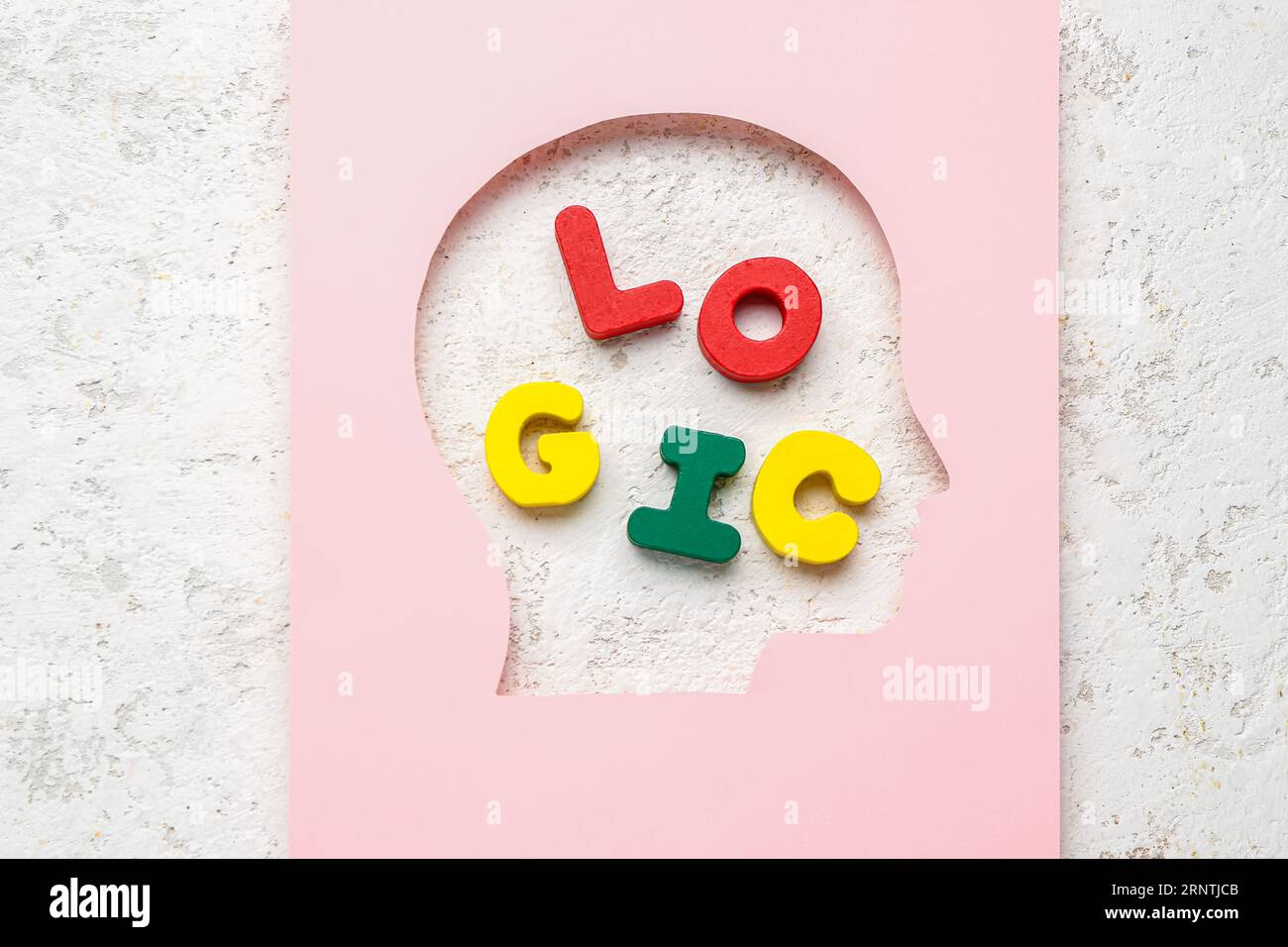 Word LOGIC visible through cut pink paper on grunge background Stock ...