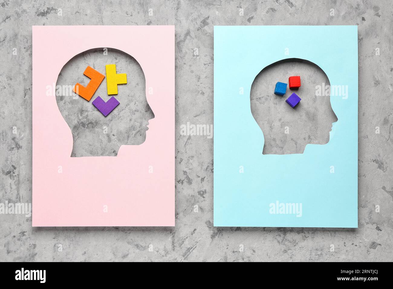 Blocks visible through cut color papers in shape of human heads on ...