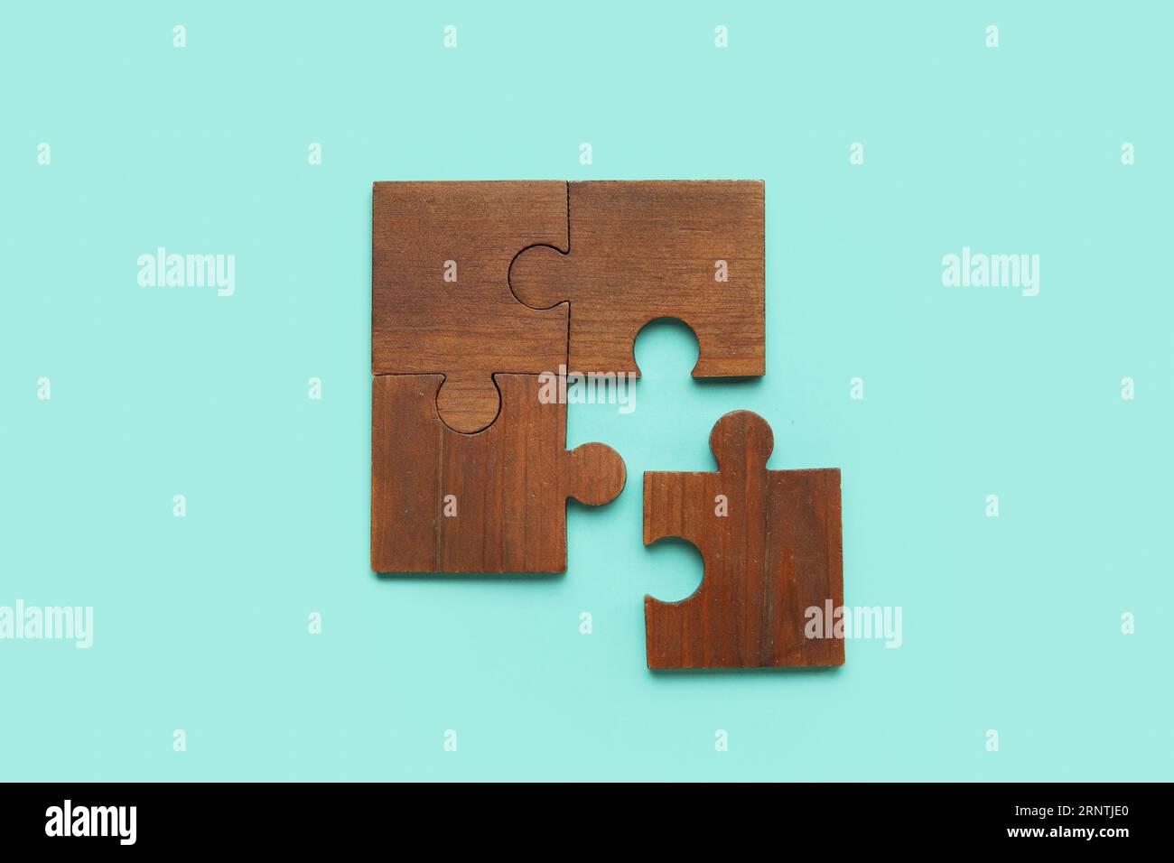 Wooden puzzle pieces on green background. Logic concept Stock Photo - Alamy