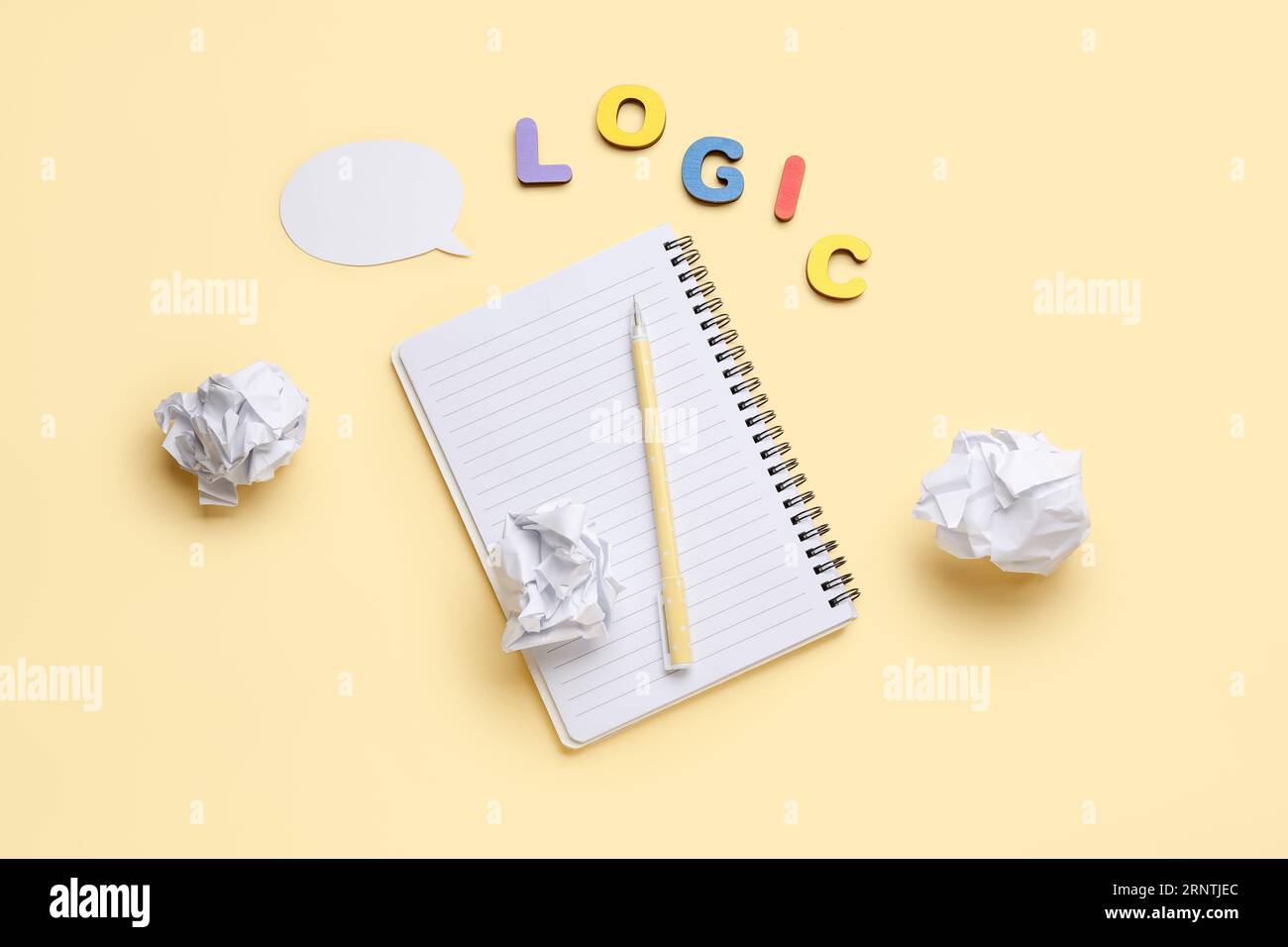 Notebook with crumpled paper, speech bubble and word LOGIC on beige ...