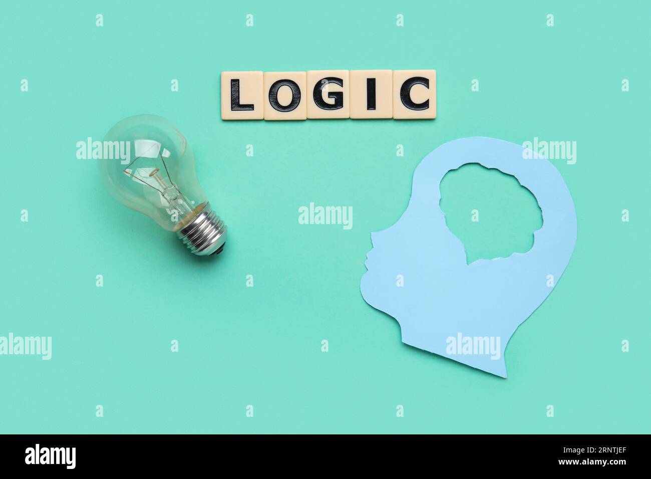 Paper human head with light bulb and word LOGIC on green background ...