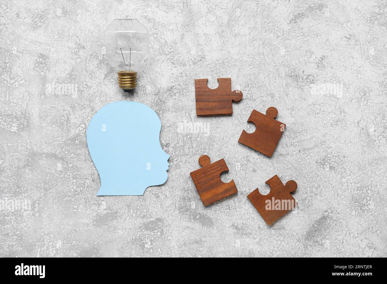 Paper human head with light bulb and puzzle pieces on grunge background ...