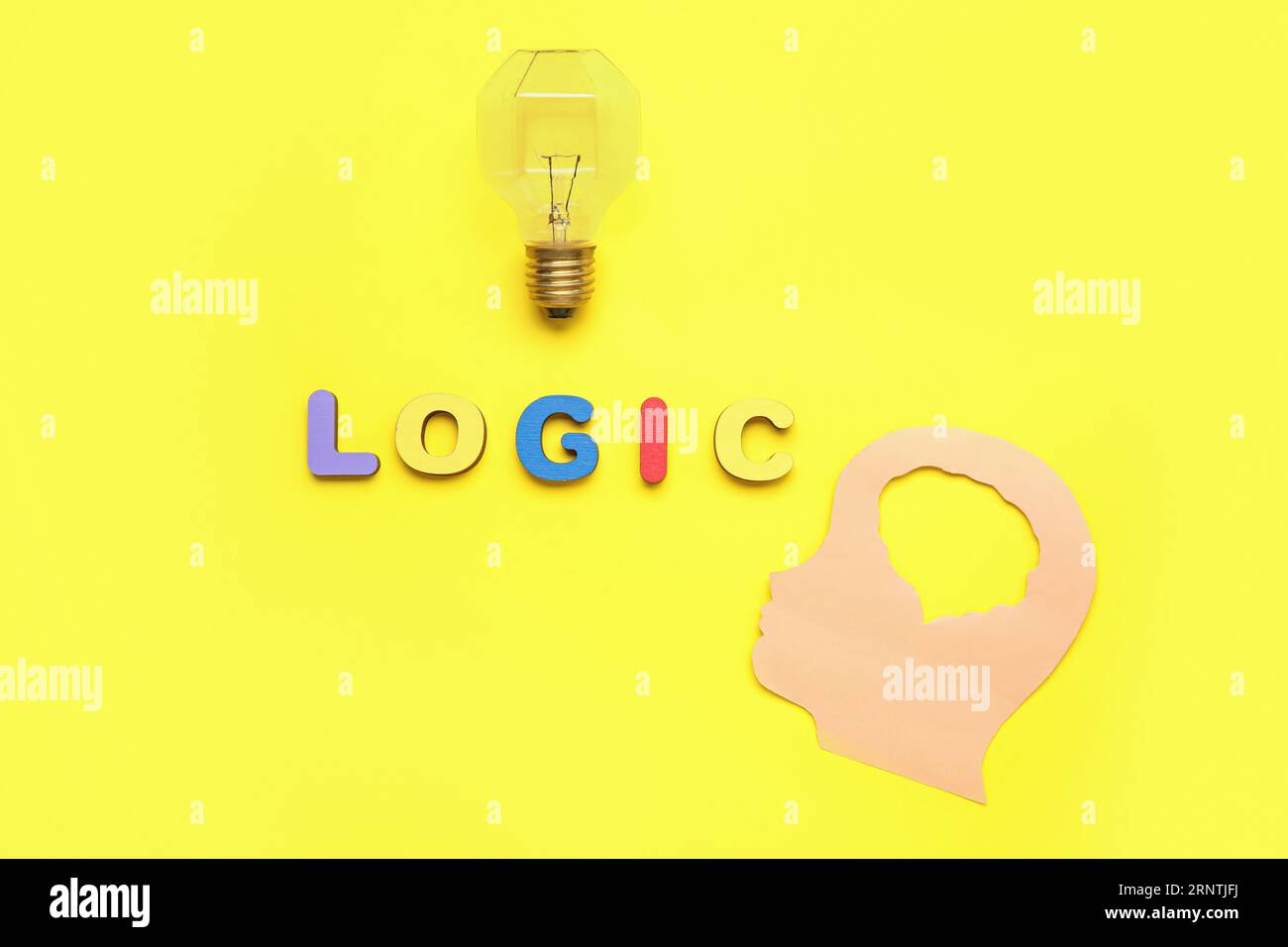 Word LOGIC with light bulb and paper human head on yellow background ...