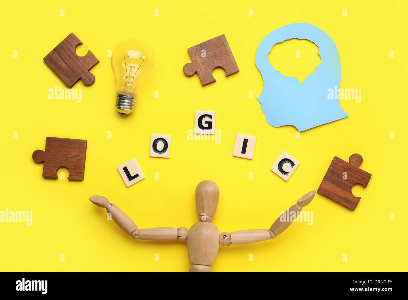 Word LOGIC with light bulb, wooden mannequin, paper human head and ...