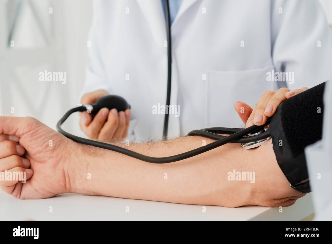 Doctor inflating blood pressure cuff hi-res stock photography and ...