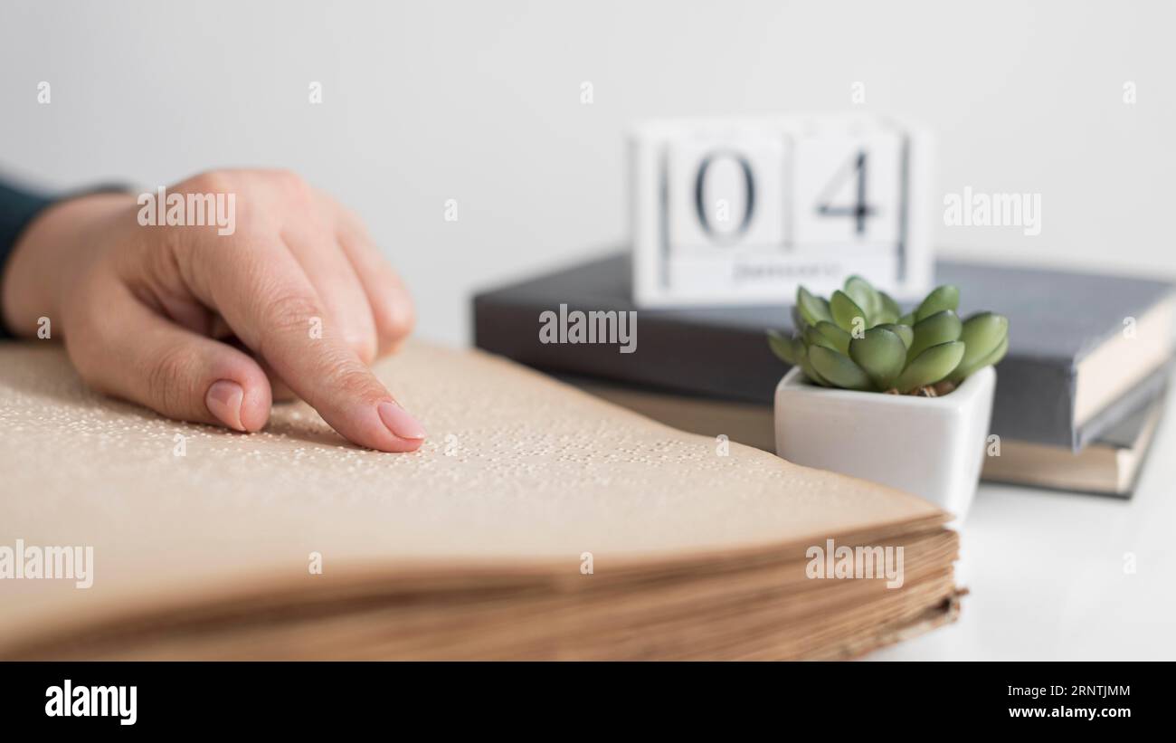 Close up hand reading old book Stock Photo - Alamy