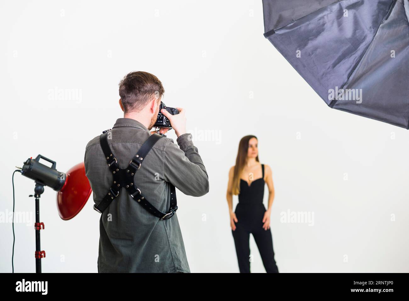 Grapher taking pictures model studio Stock Photo - Alamy