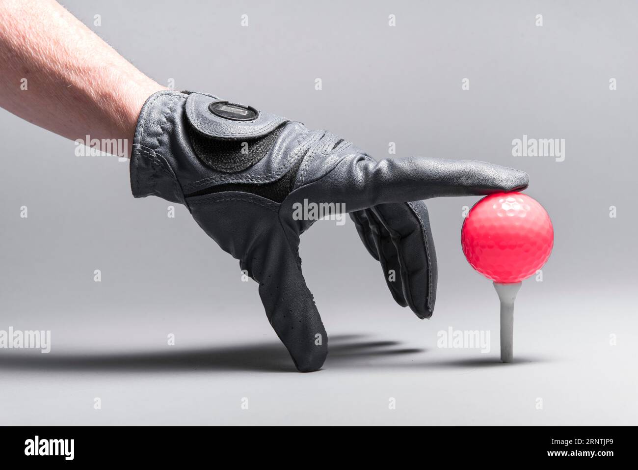 Hand arranging golf ball Stock Photo - Alamy
