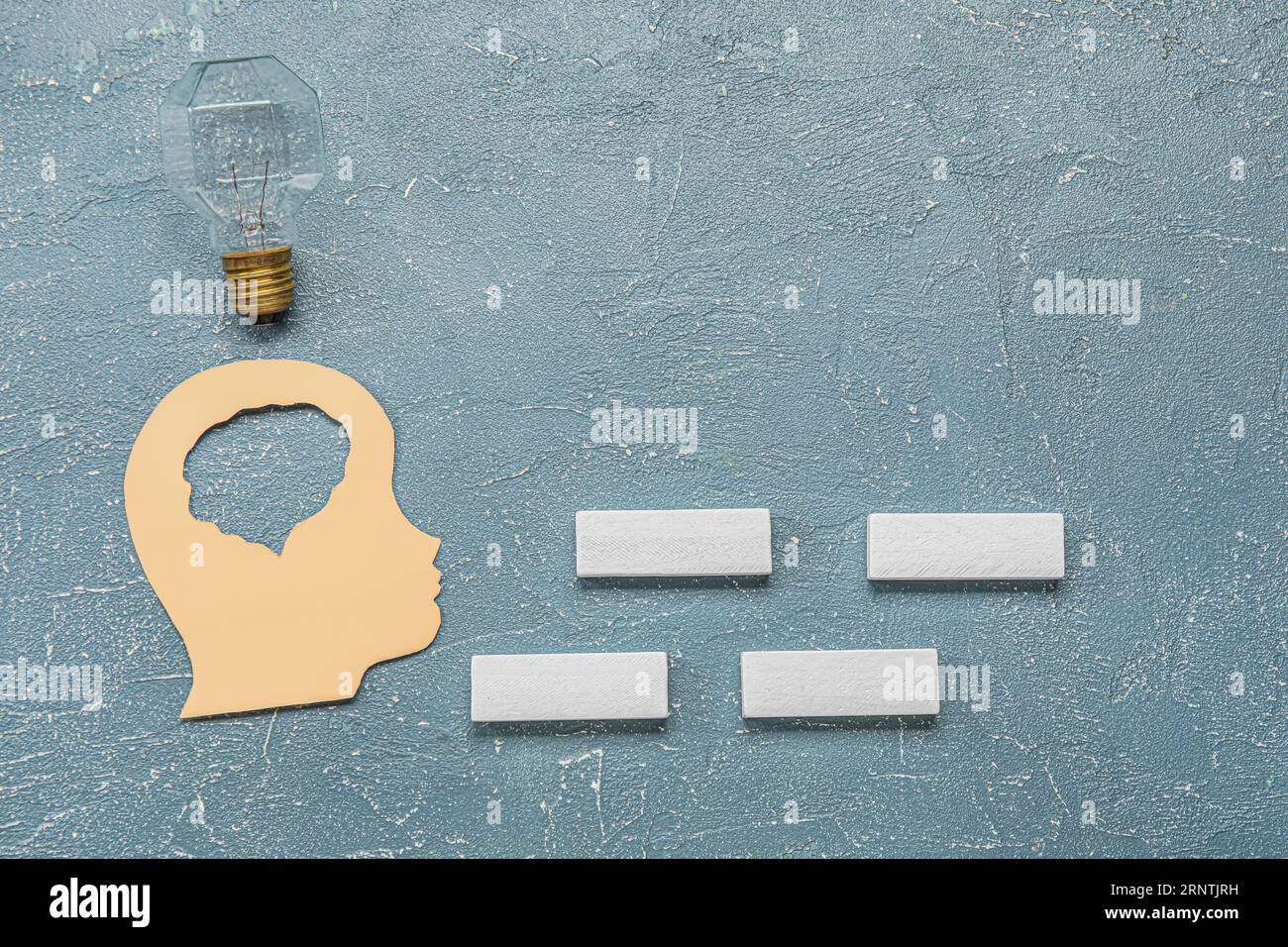 Paper human head with light bulb and blocks on grunge background. Logic ...