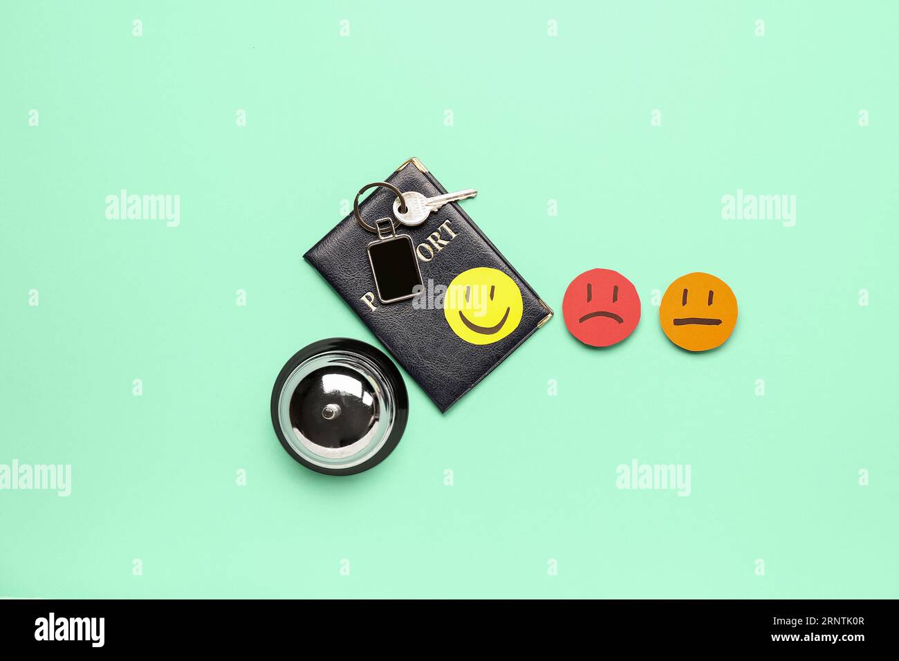 Rating smiles with passport, key from hotel room and service bell on ...