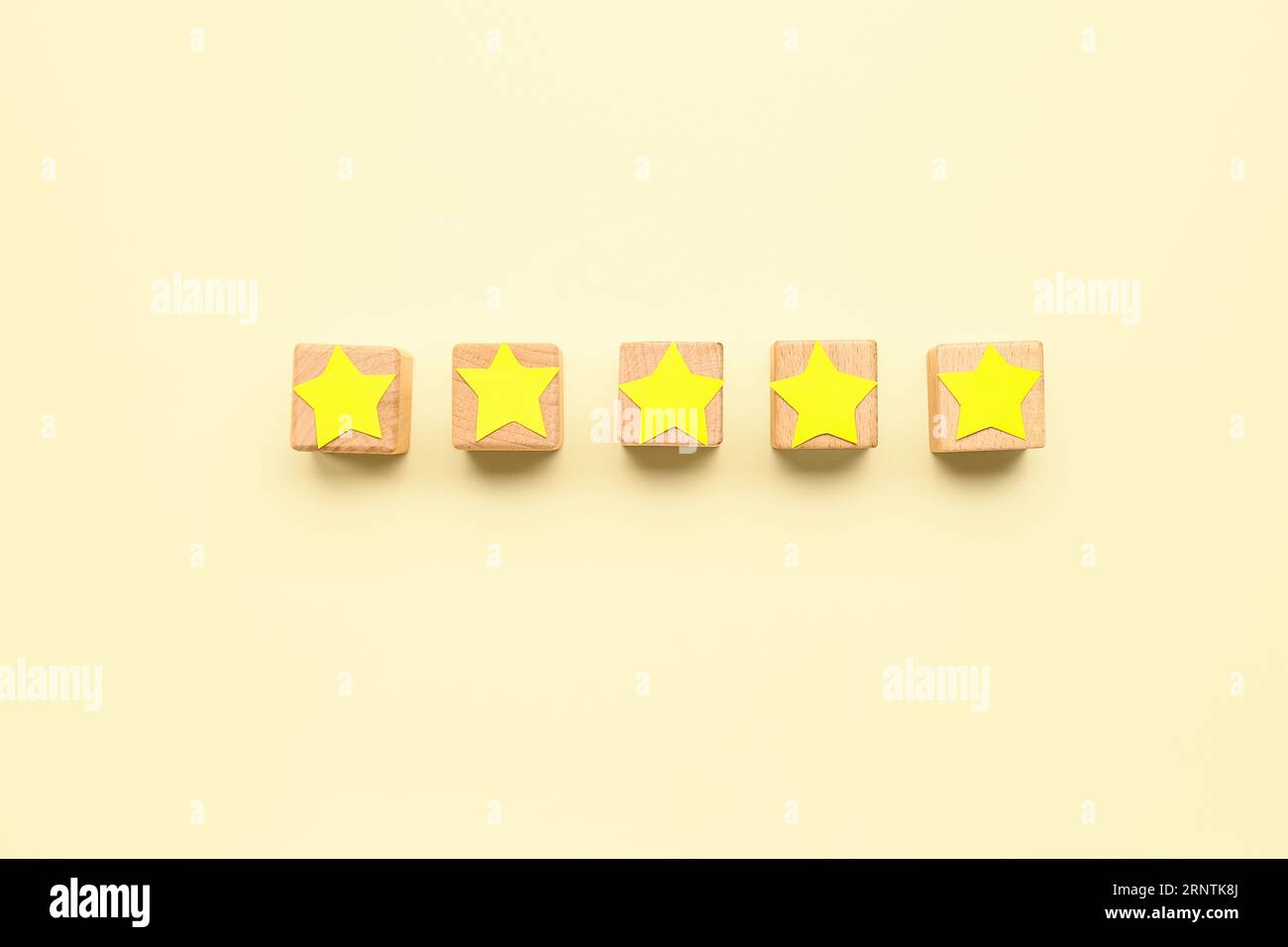 Five cubes with stars on beige background. Customer experience concept ...